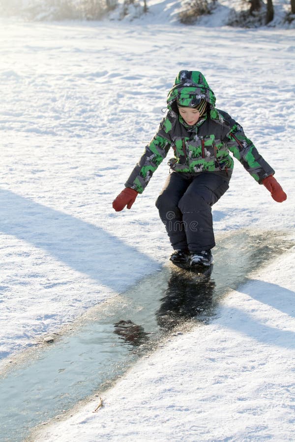 Boy Sliding on Ice Rink stock photo. Image of january - 167456392