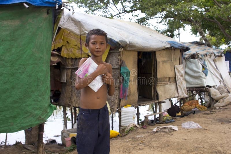 Boy in slum holding book stock photo. Image of class - 27749570