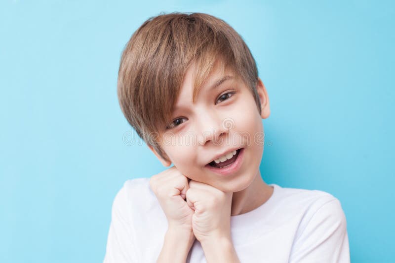 Boy smiles and is touched stock photo. Image of expression - 120444970