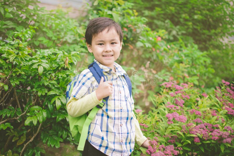 Boy Smiling with Backpack Facing Camera Stock Photo - Image of garden ...