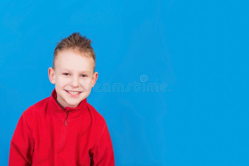 Boy is Smiling on a Blue Background Stock Photo - Image of cute ...