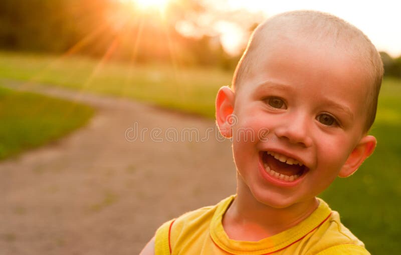 A Boy Smiling in the Camera at Sunset Background Stock Image - Image of ...