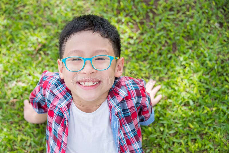 Boy smiling on grass field stock image. Image of male - 78306673