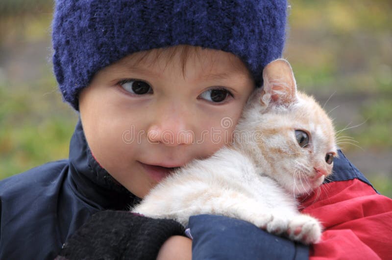 Boy smiling hugging cat stock image. Image of park, cute - 45569551