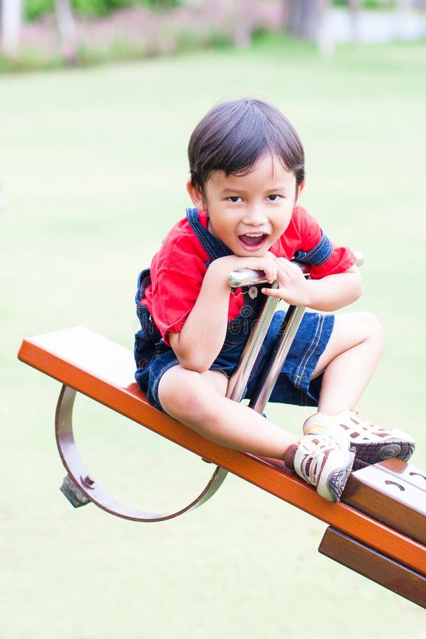 Boy Smiling and Play at the See-saw Stock Image - Image of people ...
