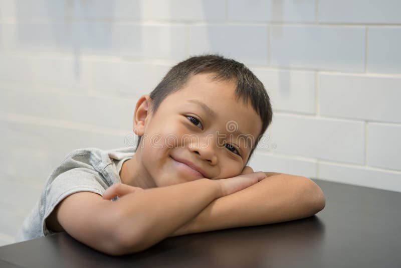 Boy Smiling while Sits at the Table Stock Photo - Image of face ...