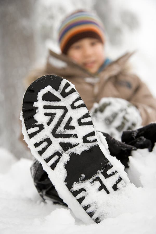 Boy with snow on his shoe stock photo. Image of clean - 62534570