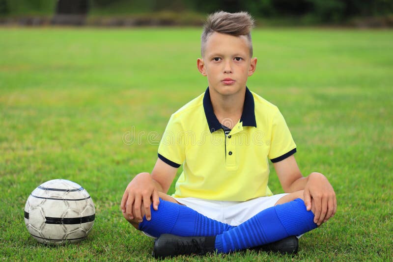 Boy Soccer Player Sitting on the Soccer Field Stock Image - Image of ...