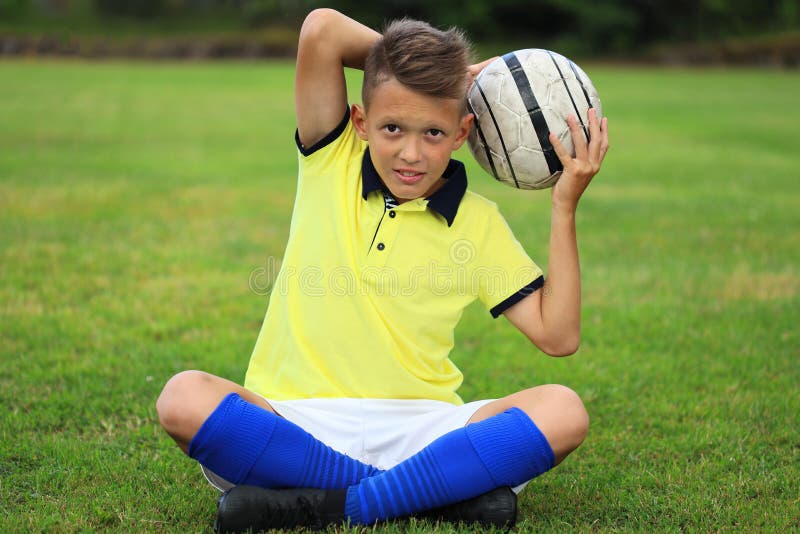 Boy Soccer Player Sitting on the Soccer Field Stock Photo - Image of ...