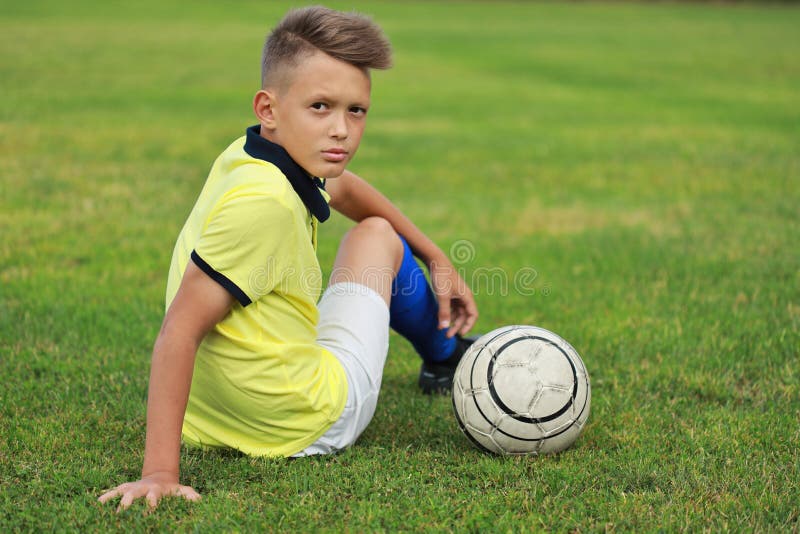 Boy Soccer Player Sitting on the Soccer Field Stock Photo - Image of ...