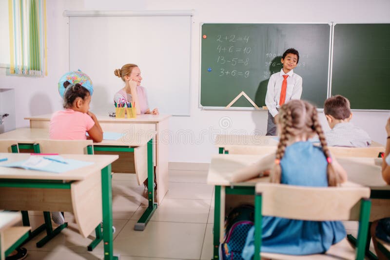 Boy Solving Addition and Subtraction on Board. Schoolboy Writing ...