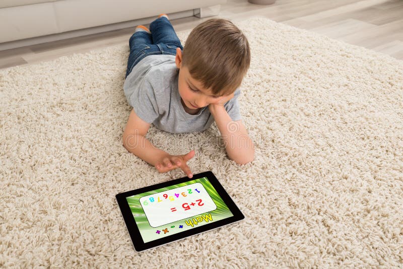 Boy Solving Math Problem on Digital Tablet Stock Photo - Image of lying ...