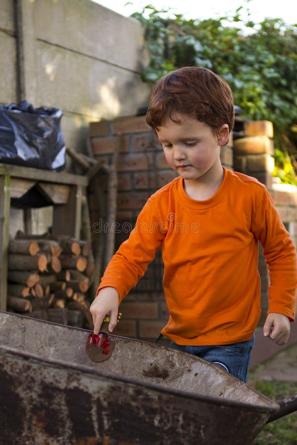 Boy with Spade and Wheelbarrow Stock Photo - Image of outdoors, child ...