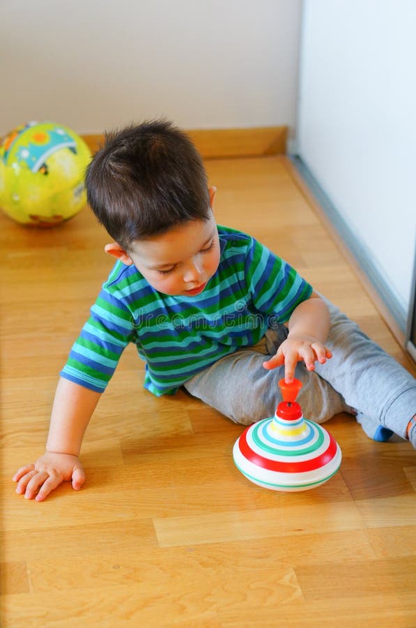 Boy and spin top stock photo. Image of years, play, child - 67039764