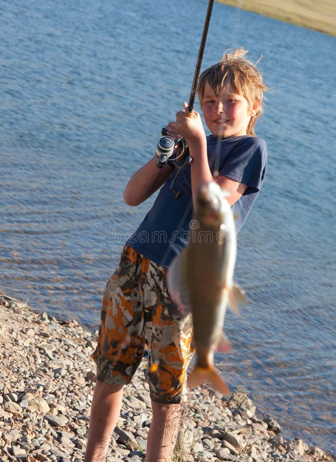 The Boy with a Spinning Catch Grayling Stock Photo - Image of catching ...