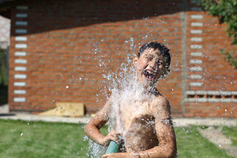Boy with Splash Water in Hot Summer Day Outdoors Stock Photo - Image of ...