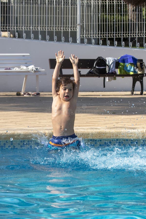 Boy Splashing into Pool Water with Joy Stock Photo - Image of pool ...