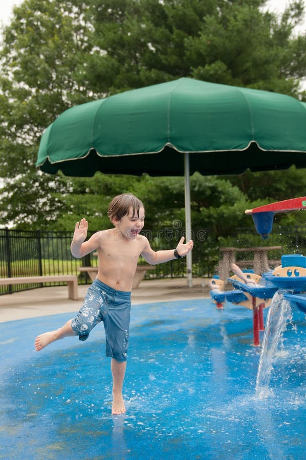 Boy Splashing at Water Spray Park Stock Image - Image of camp, hose ...