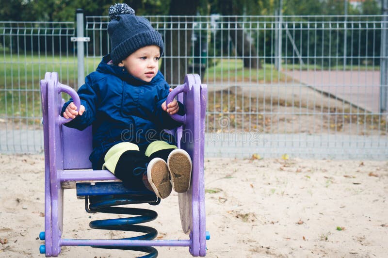 Boy by spring swing stock image. Image of years, park - 79058503
