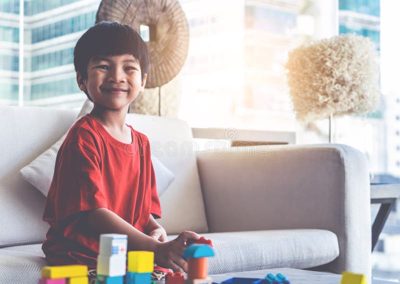 Boy Stacking Toy Blocks on a Living Room for Educational Toy Stock ...