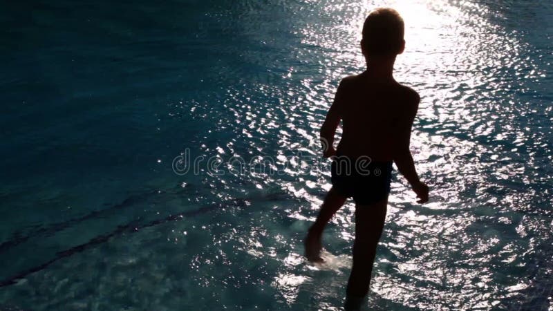 Boy Stand in Pool and Splutter Water by Leg Making Stock Video - Video ...