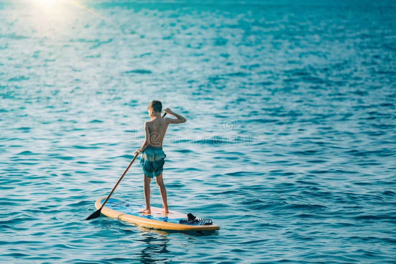 Boy on Stand Up Board or SUP Stock Image - Image of holiday, child ...
