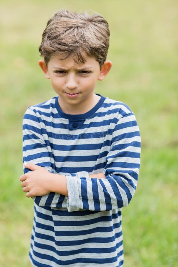 Boy Standing with Arms Crossed in Park Stock Photo - Image of grass ...