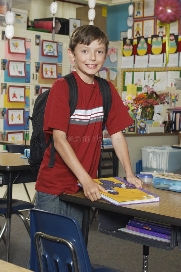 Boy Standing in Classroom stock image. Image of classroom - 29662013