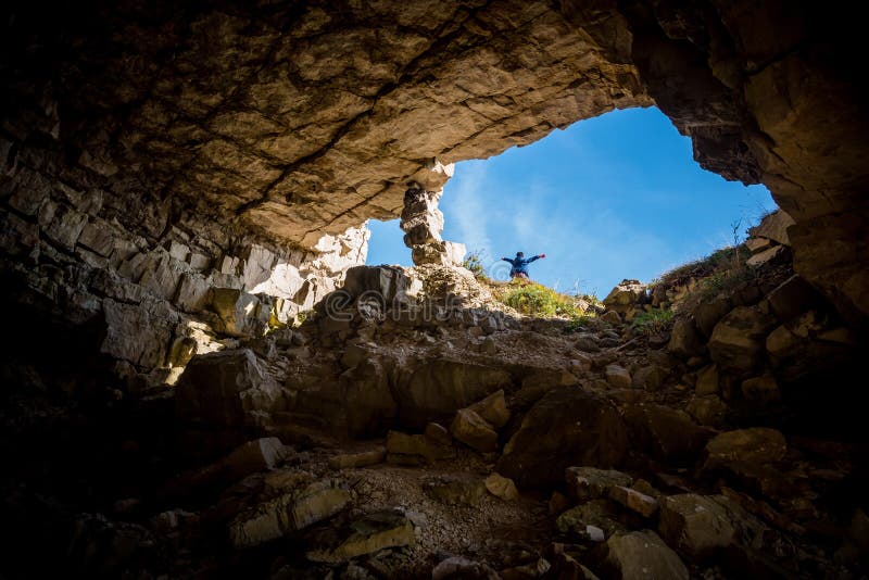 Boy Standing in Front of a Cave Entrance Stock Image - Image of nature ...