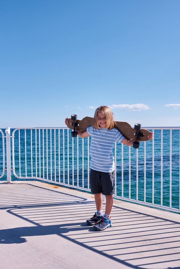 Boy Standing with a Longboard on a Pier at Sunny Day Stock Photo ...