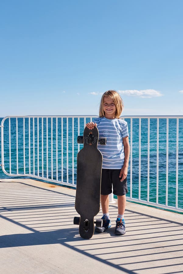 Boy Standing with a Longboard on a Pier at Sunny Day Stock Image ...