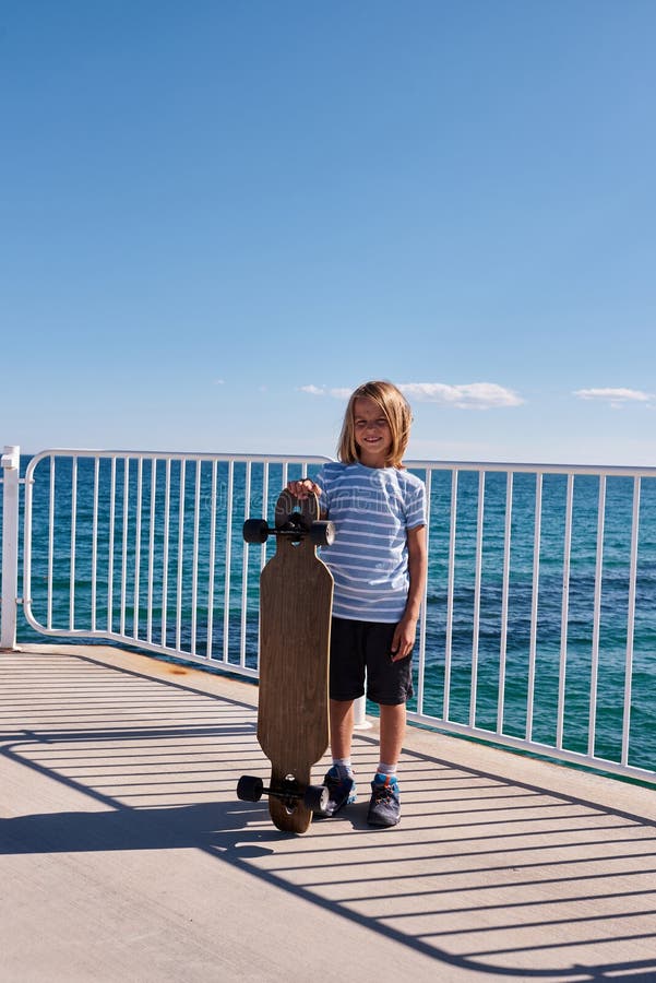 Boy Standing with a Longboard on a Pier at Sunny Day Stock Photo ...