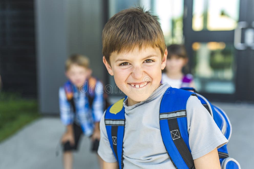 Boy Standing Outside School with Bag Stock Image - Image of junior ...