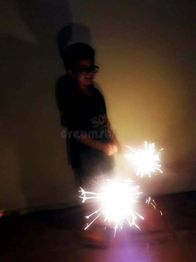 A Boy Standing Playing Fireworks with His Hands Stock Image - Image of ...