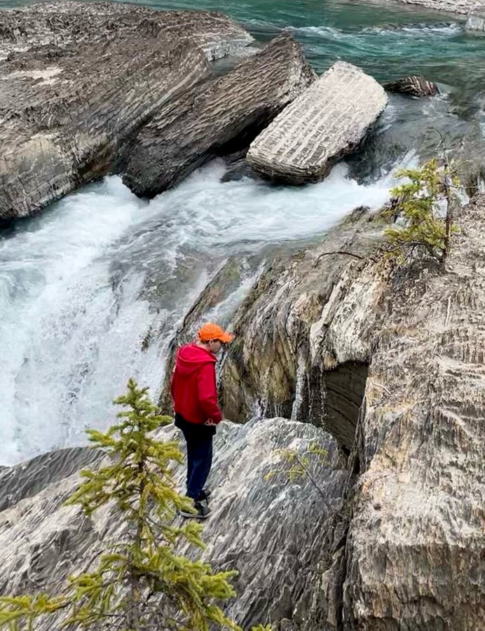 Boy Standing on a Rock Near the Raging Waterfall Stock Image - Image of ...