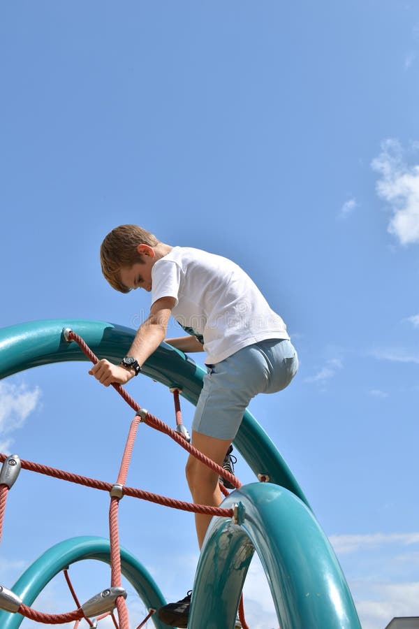 A Boy Standing on the Ropes on the Playground Stock Photo - Image of ...