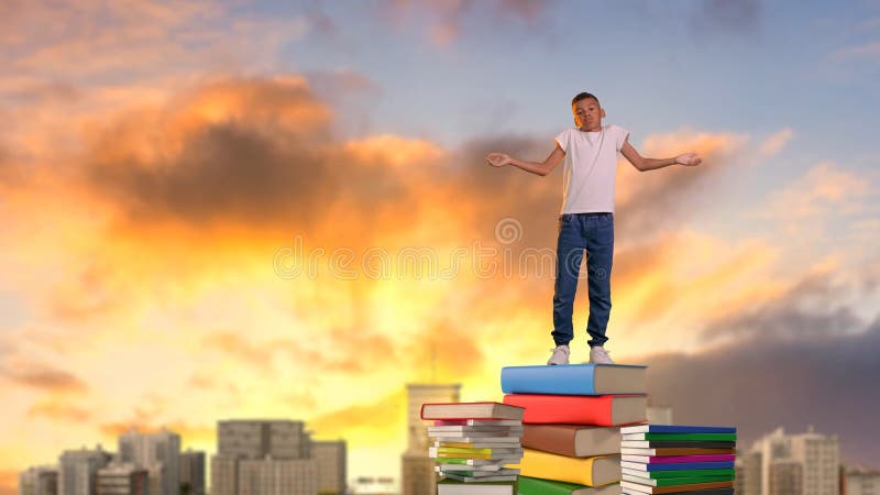 Boy Standing on a Stack of Colored Books and Thinking about Something ...