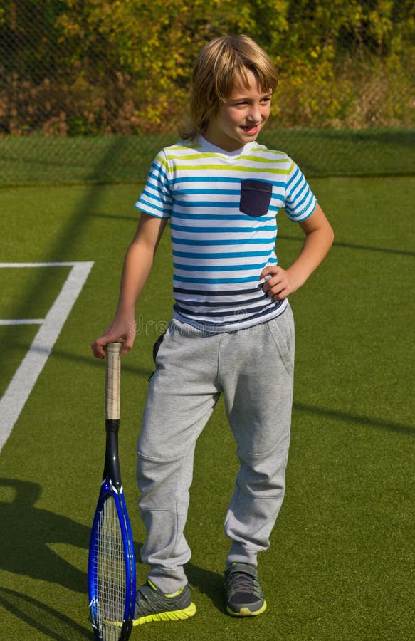 Boy Standing with Tennis Racket and Ball on the Court Stock Image ...