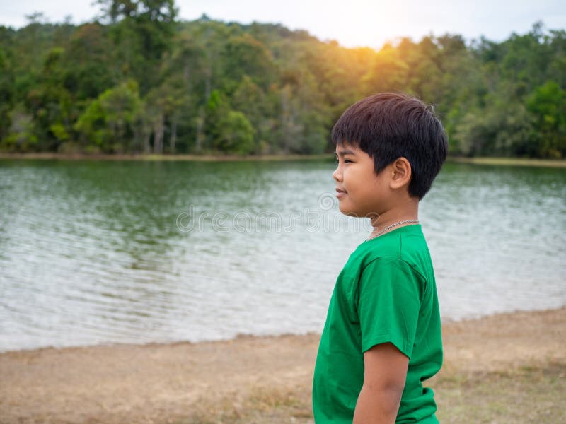 A Boy Stands by the Reservoir in the Evening. it Shows Looking at the ...