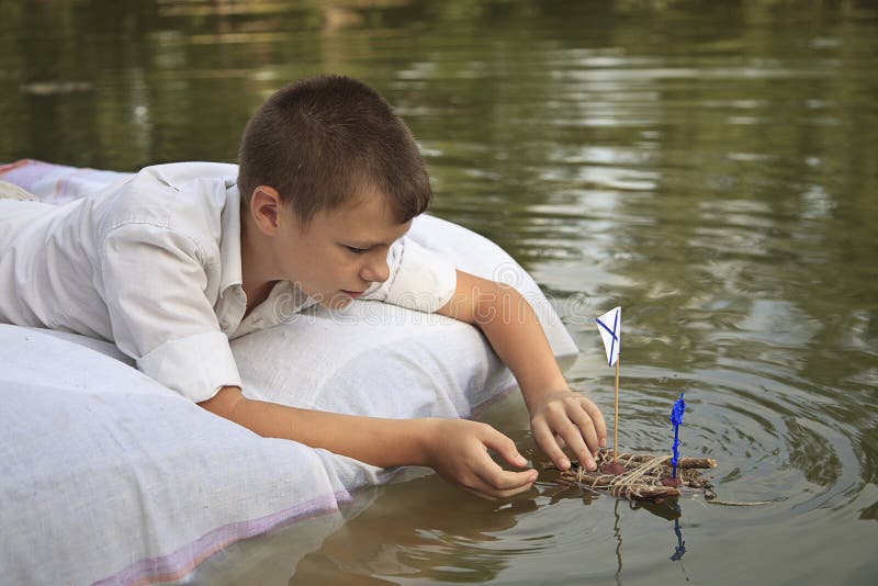 The Boy Starts a Raft on the River Stock Image - Image of summer, river ...