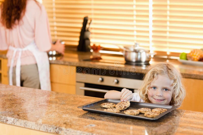 Boy Stealing a Cookie while His Mother is Not Watching Stock Photo ...