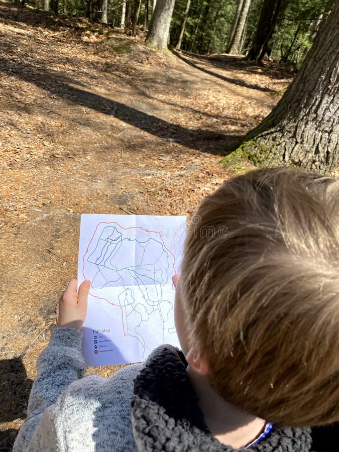 Boy Stopping on Nature Path To Look at a Trail Map Stock Photo - Image ...