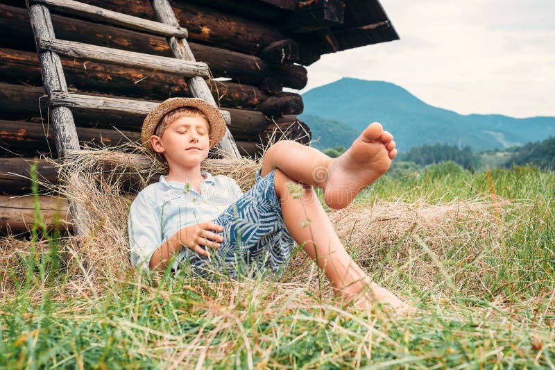 Boy in Straw Hat Lies in Hay Near the Barn Stock Photo - Image of ...