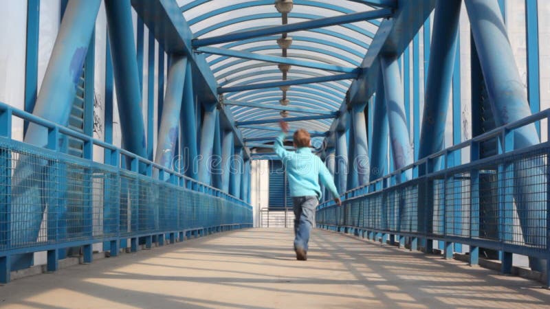 Boy strides on pedestrian stock video. Video of modern - 321013959