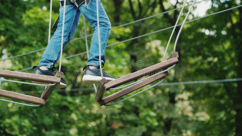 The Boy is Stuck on a Rope Obstacle, Can Not Make a Step. Overcome the ...