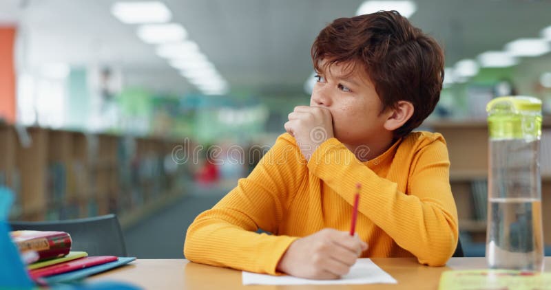 Boy, Student and Thinking for Homework at Library in School with ...
