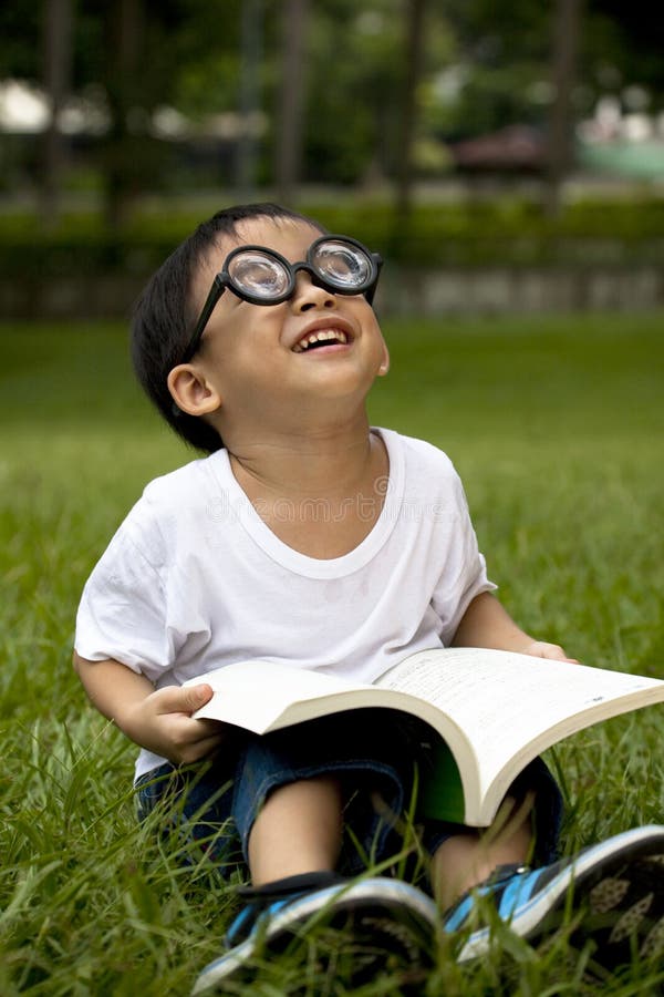 Boy Study on the Green Grass Stock Image - Image of children, looking ...