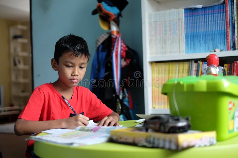 A boy study at his bedroom stock photo. Image of male - 117719284