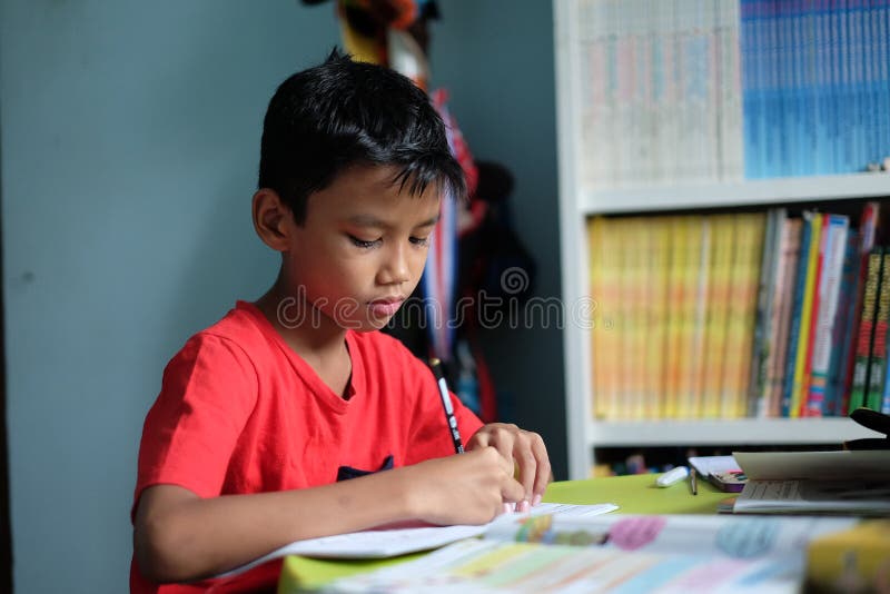 A boy study at his bedroom stock photo. Image of writing - 117720236