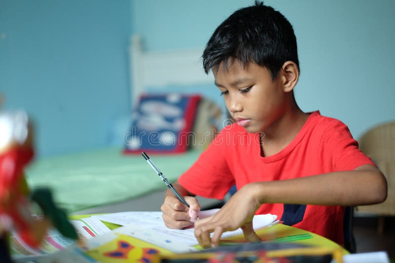 A boy study at his bedroom stock photo. Image of pencil - 117724002